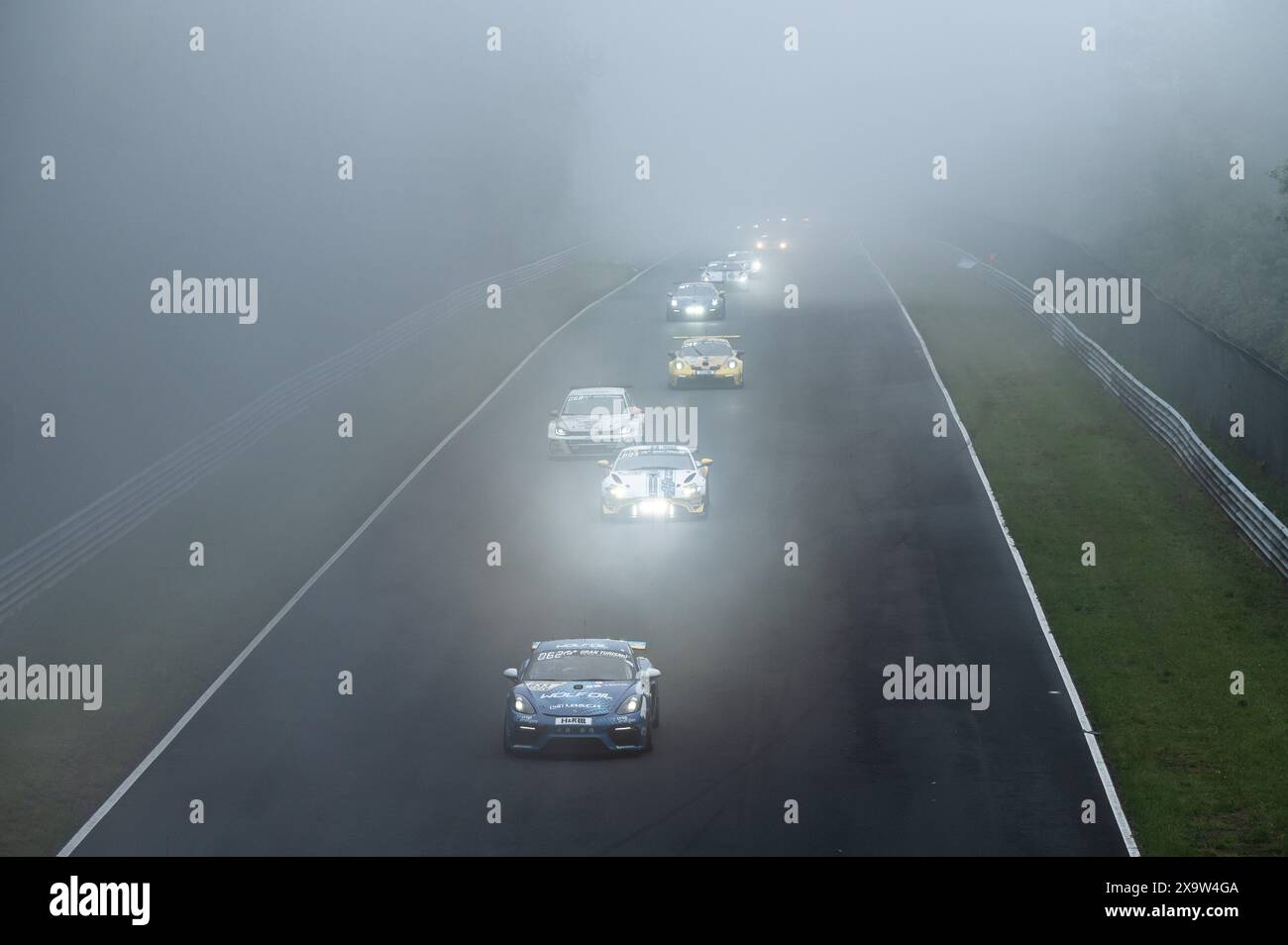 02 June 2024, Rhineland-Palatinate, Nürburg: Racing cars drive through ...