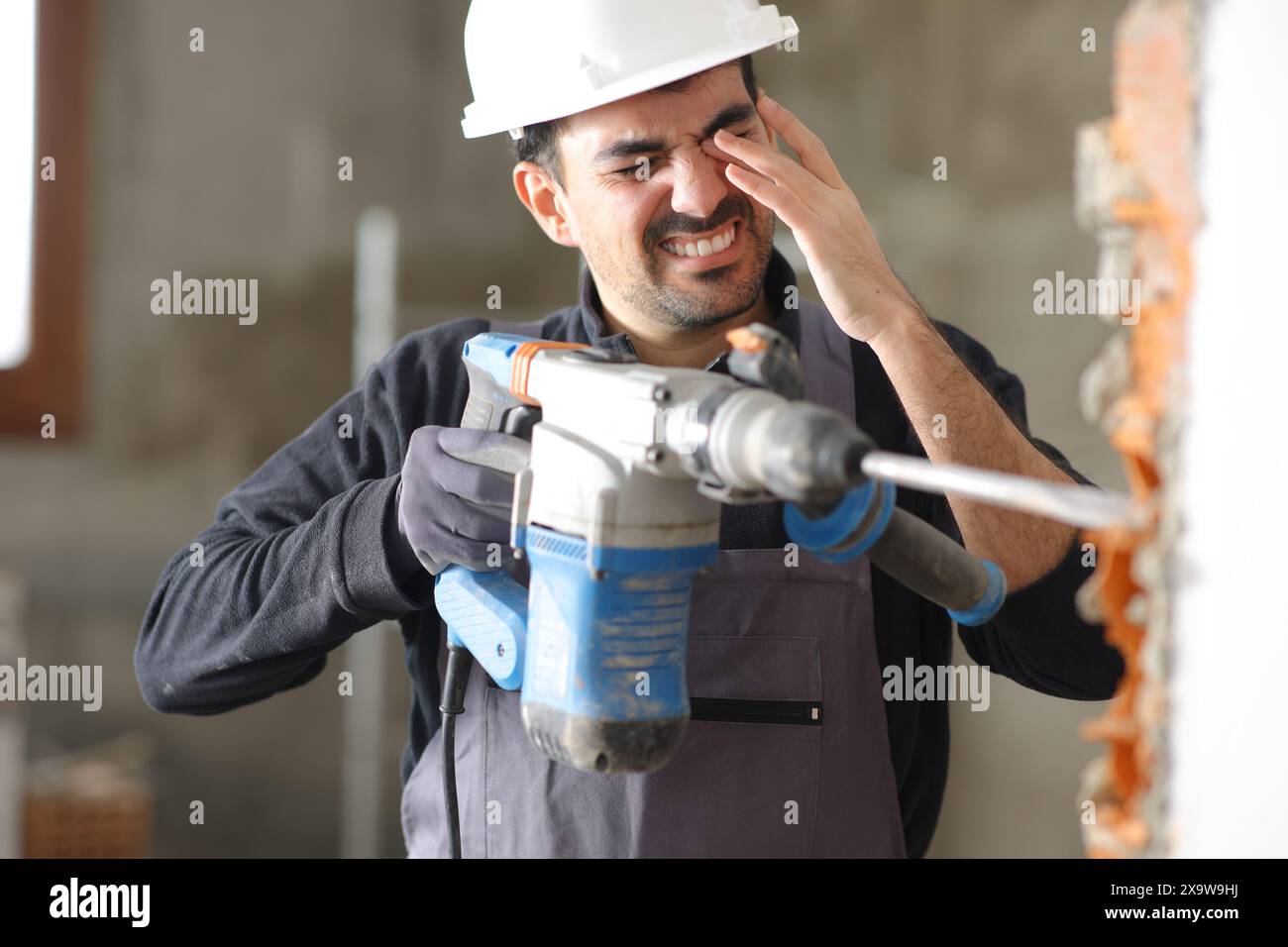 Construction worker suffering accident in an eye working with a rotary ...