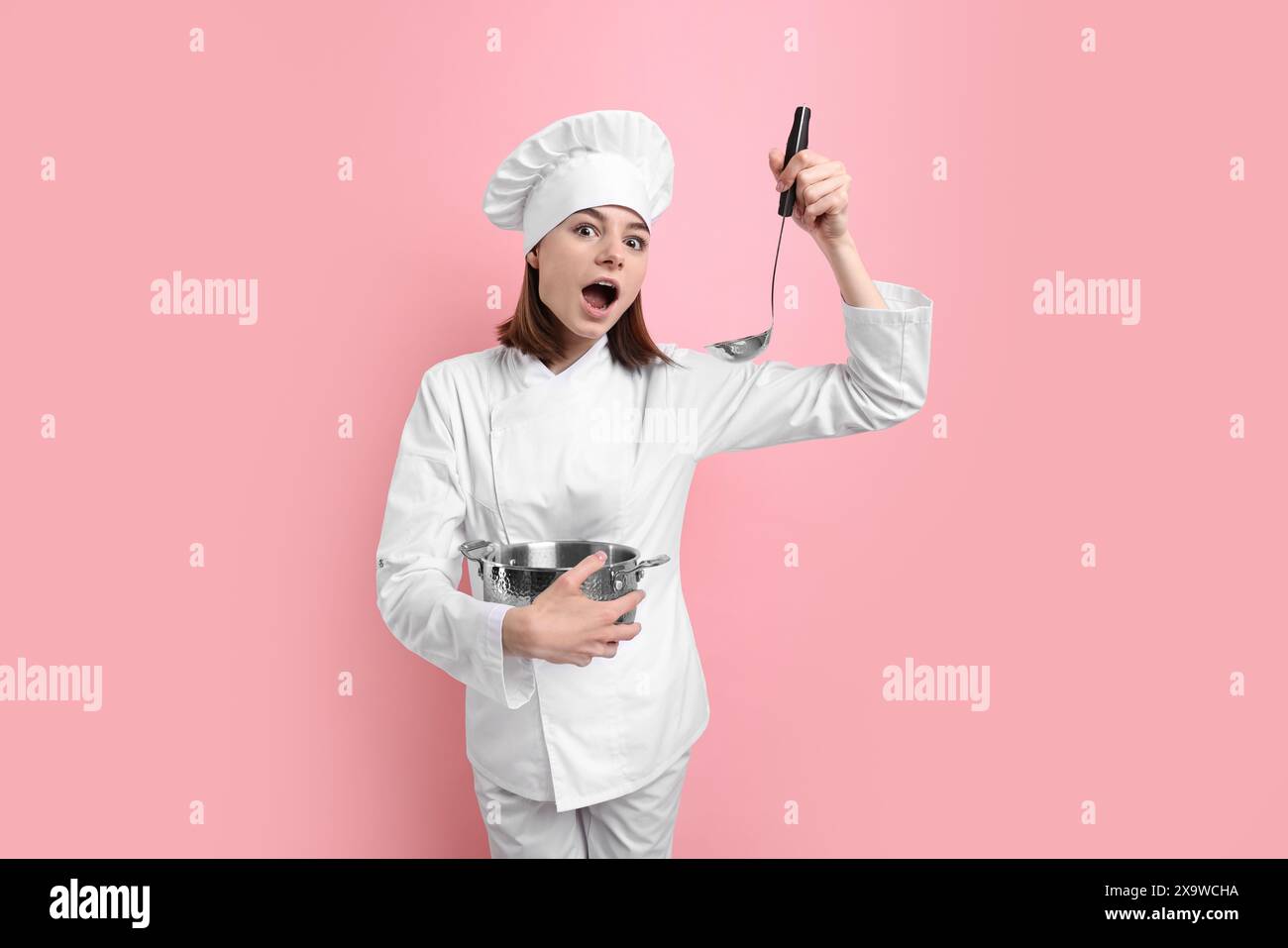 Professional chef cooking pot and ladle on pink background Stock Photo ...