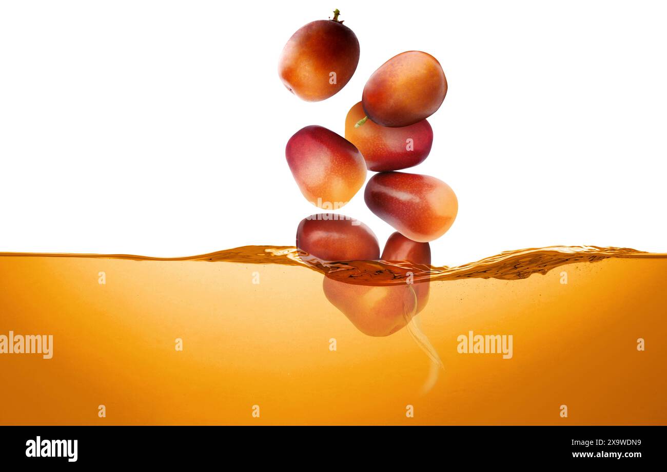 Palm fruits falling into cooking oil on white background Stock Photo ...