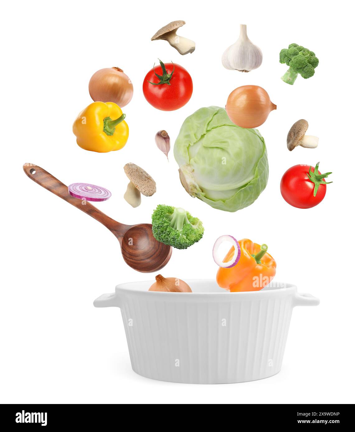 Fresh ingredients falling into saucepan on white background Stock Photo ...
