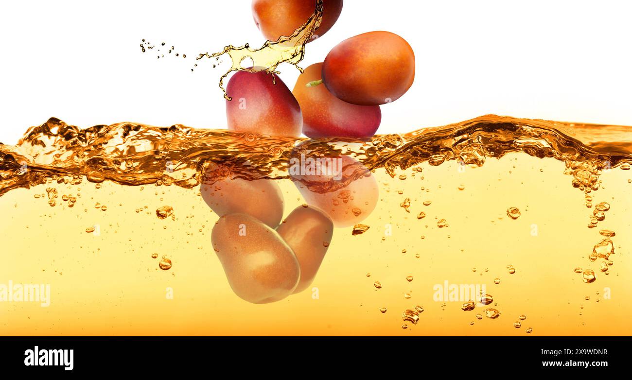 Palm fruits falling into cooking oil on white background Stock Photo ...