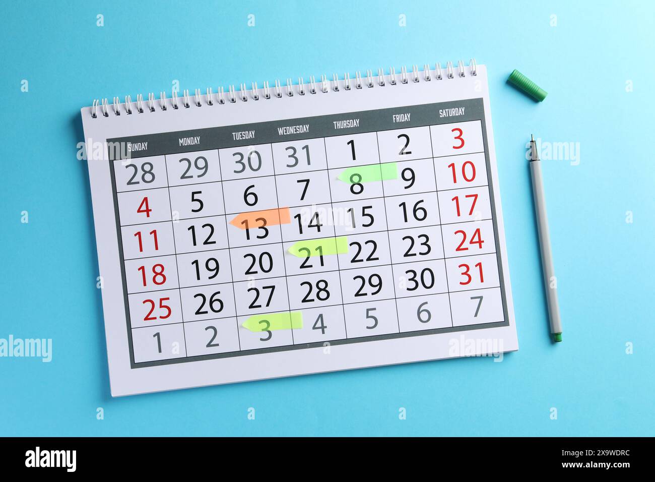 Timetable. Calendar with marked dates and pen on light blue background ...