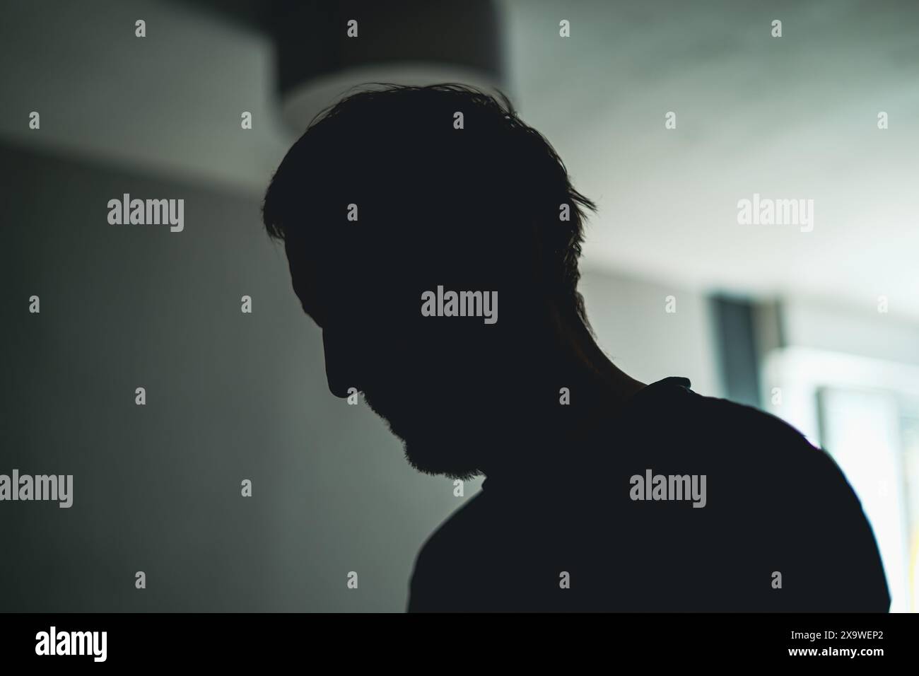 Social alienation concept, silhouette of self-estrangement male in dark ...