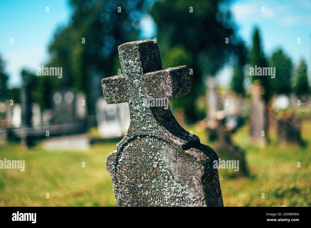 Old concrete christian cross tombstone on a cemetery graveyard burial ...
