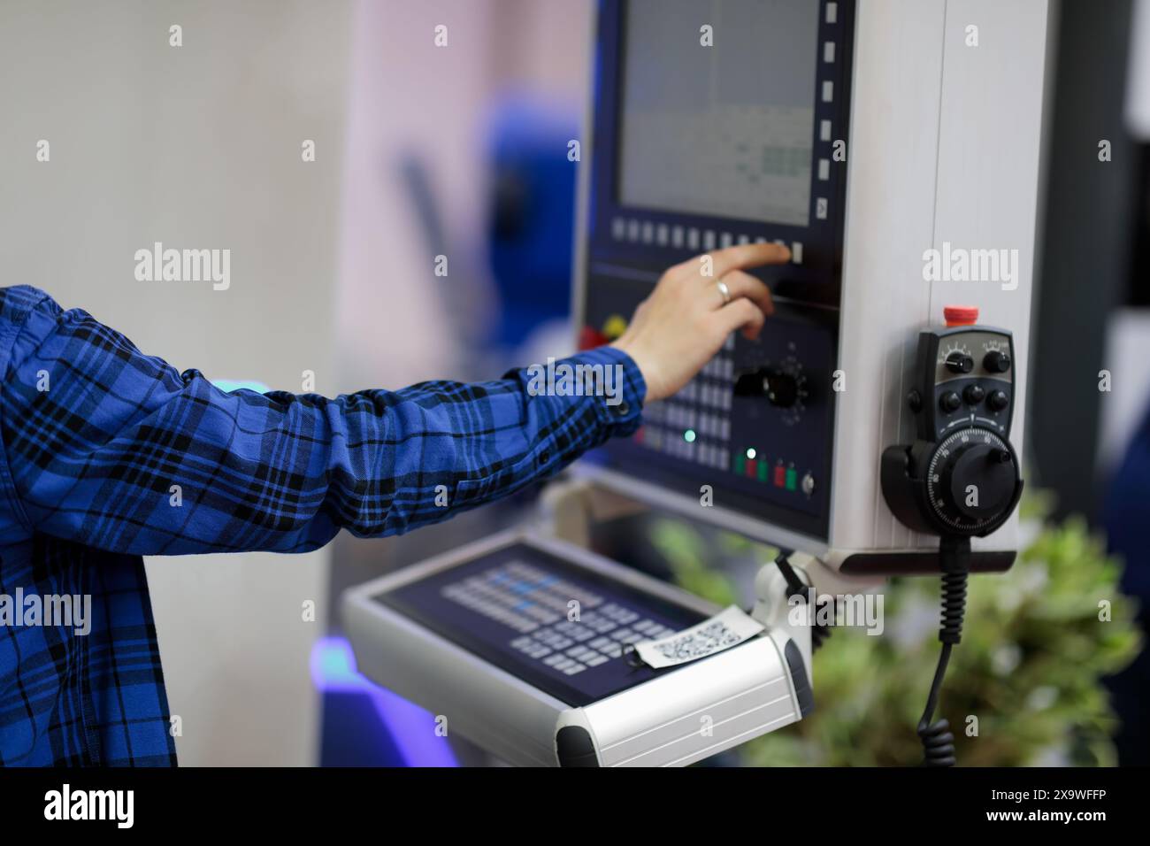 CNC machine operator working with control console. Selective focus ...