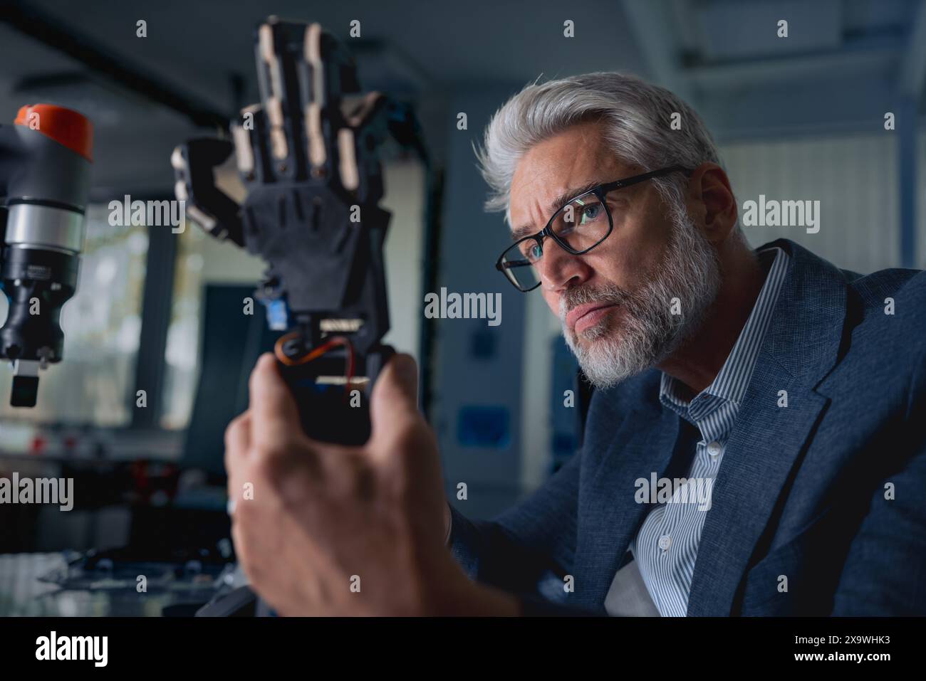 Robotics engineer adjusting, calibring robotic prosthetic hand. Concept ...