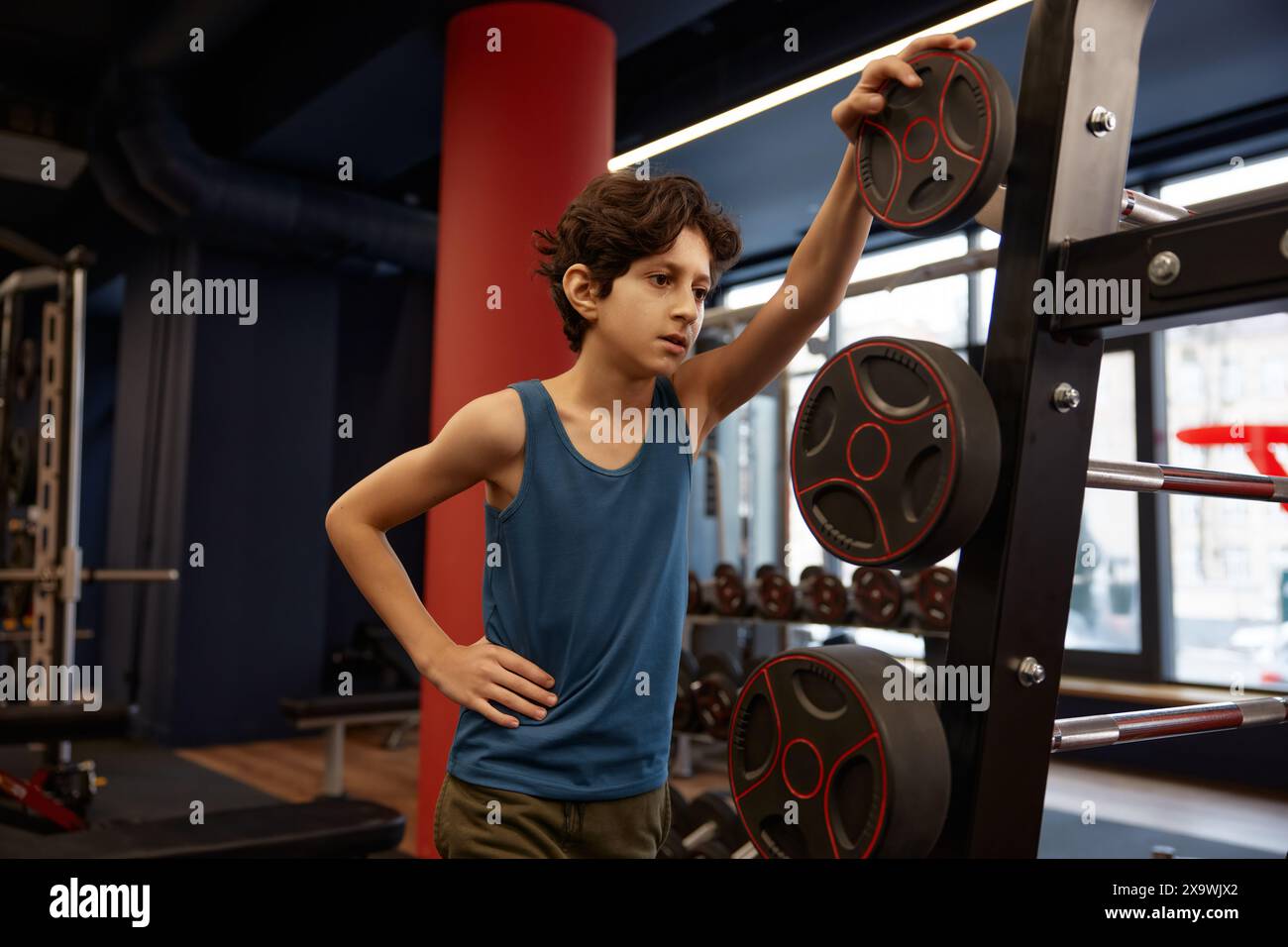 Tired preteen boy wiping sweat from his forehead with hand after ...