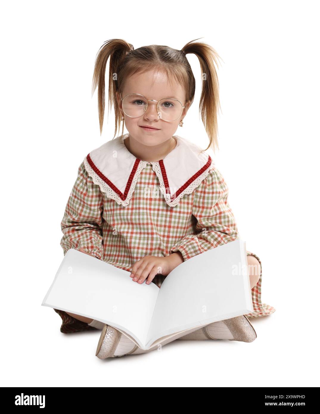 Cute little girl with book on white background Stock Photo - Alamy