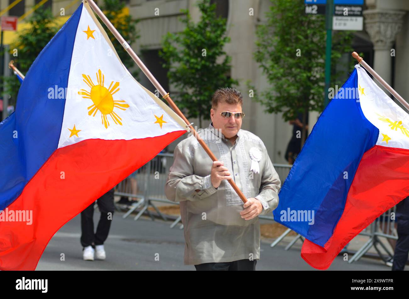 A participant march with a Philippino flag during the 34th Annual ...