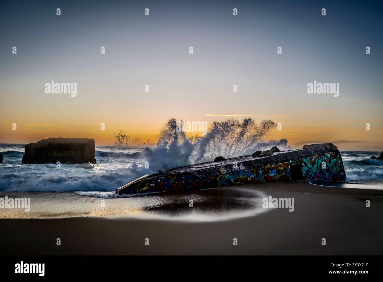 Military bunker from World War II with sunset and fountain of a wave on ...