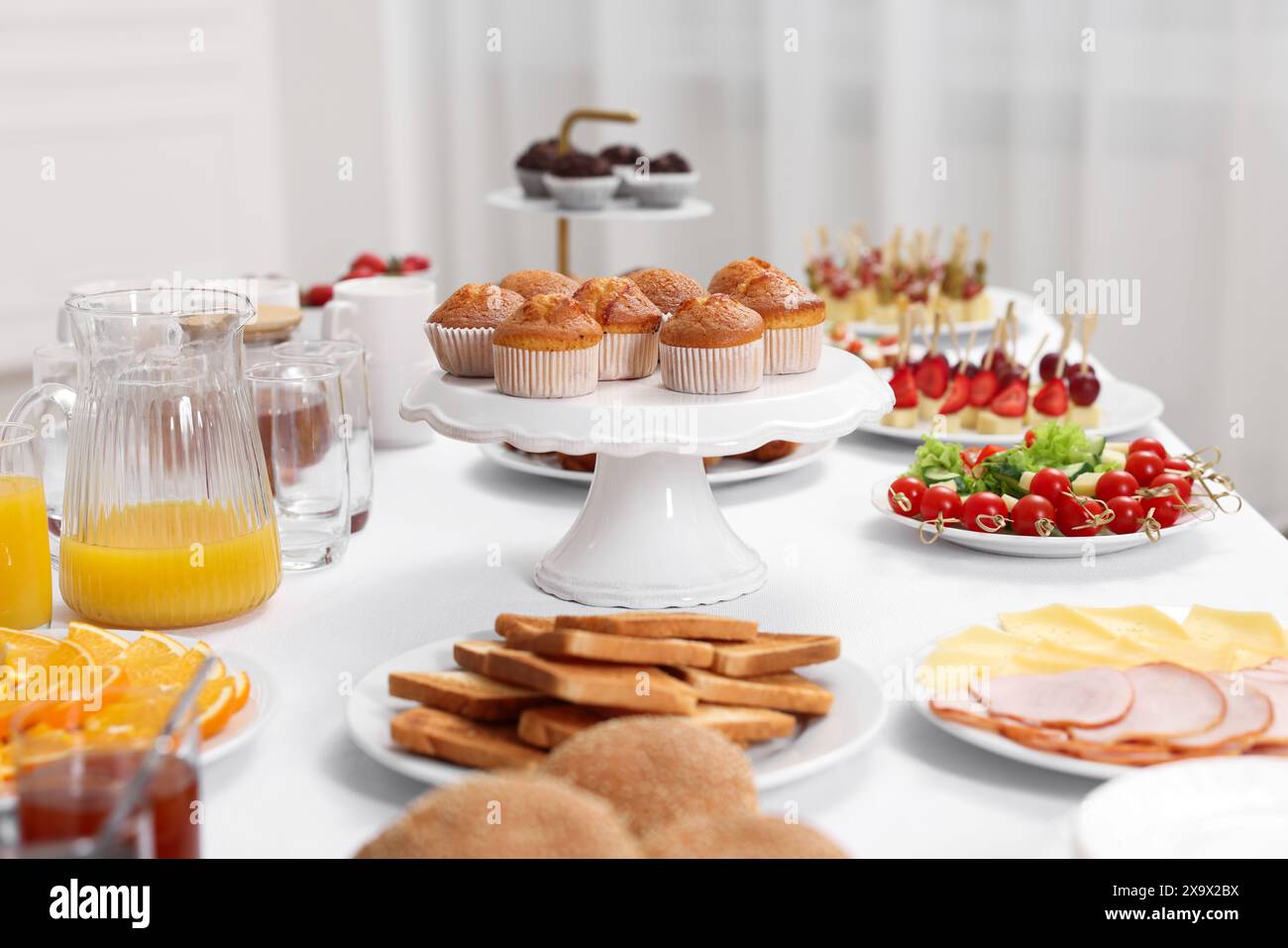 Different meals served on white table indoors. Buffet menu Stock Photo ...