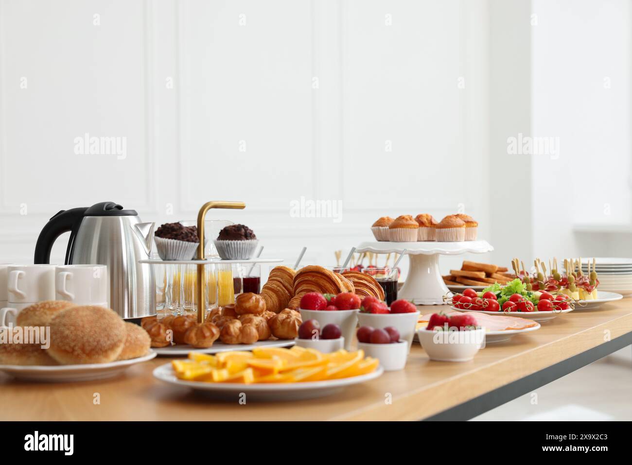 Different meals served on wooden table indoors, closeup. Buffet menu ...
