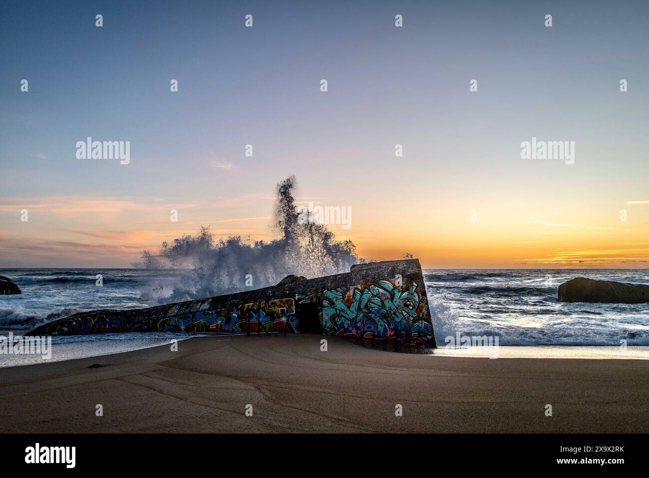 Military bunker from World War II with sunset and fountain of a wave on ...