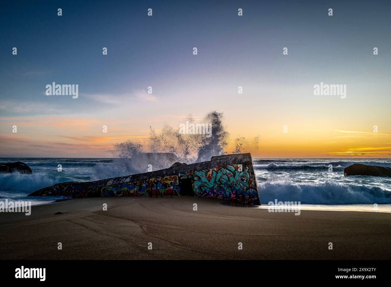 Military bunker from World War II with sunset and fountain of a wave on ...