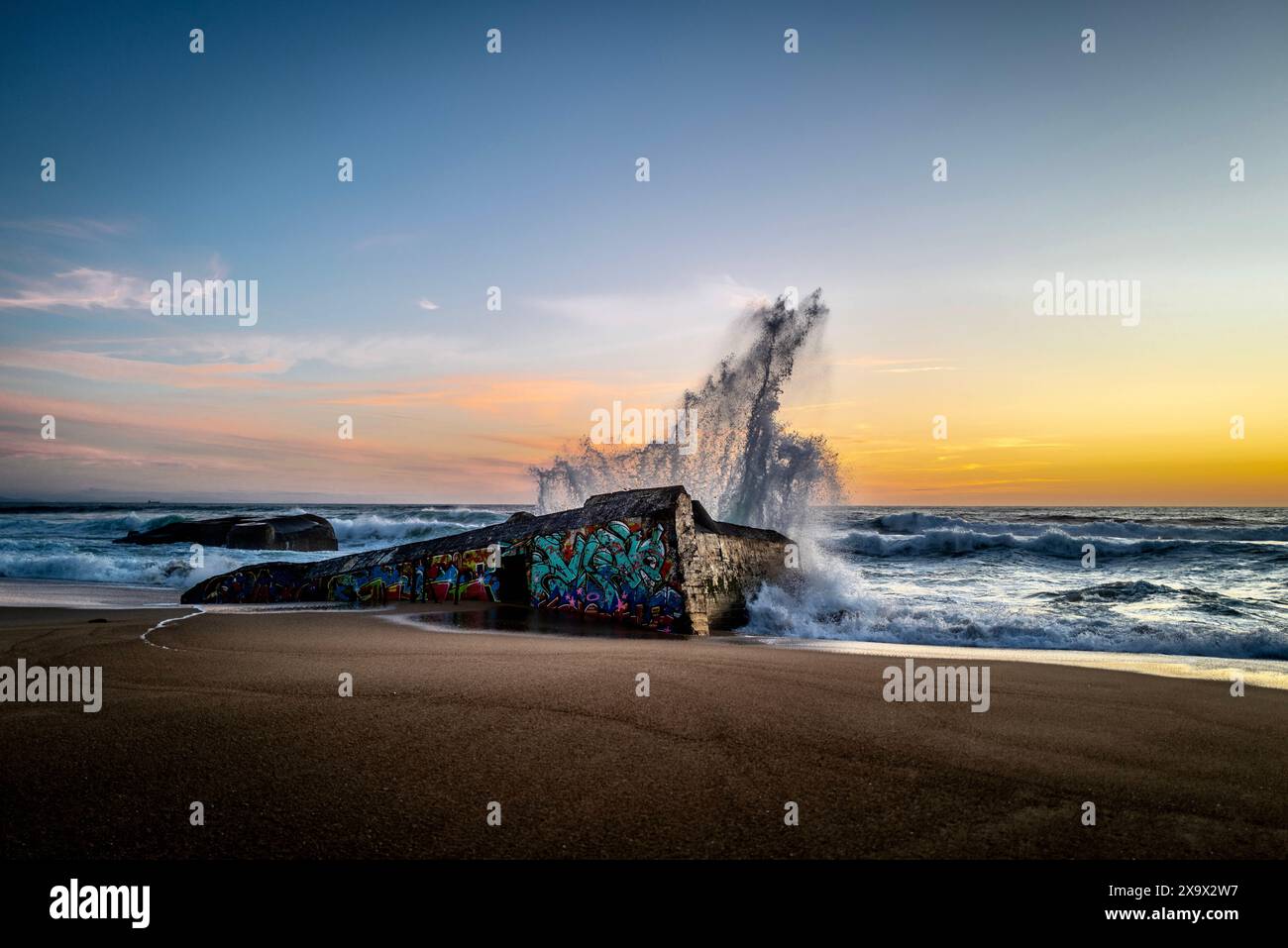 Military bunker from World War II with sunset and fountain of a wave on ...