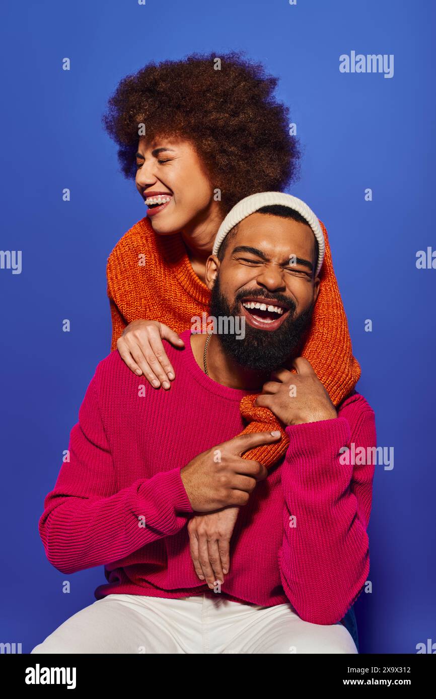 A man with a beard tenderly hugs a woman, their vibrant attire ...