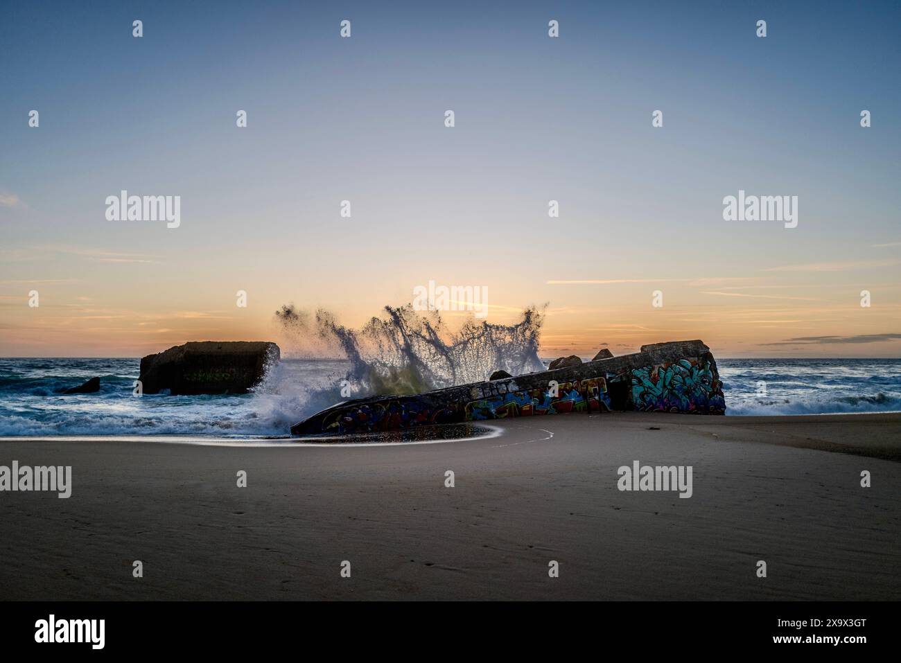 Military bunker from World War II with sunset and fountain of a wave on ...