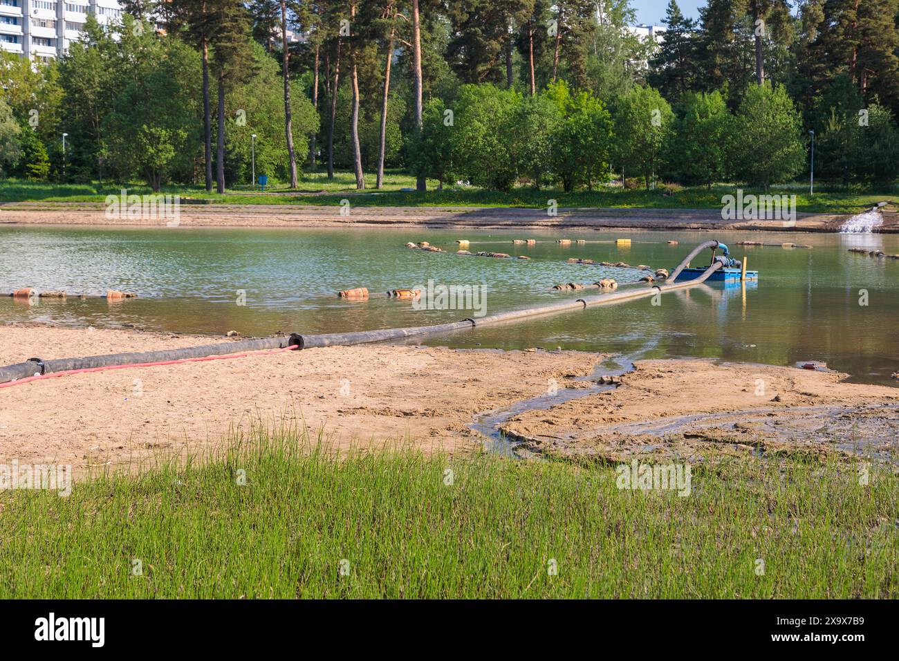 Pump and pipes for cleaning the bottom of the city pond Stock Photo - Alamy