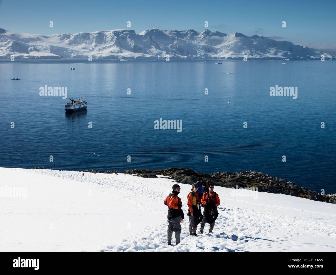 Tourists descending a snow slope at Palaver Point, Two Hummock Island ...