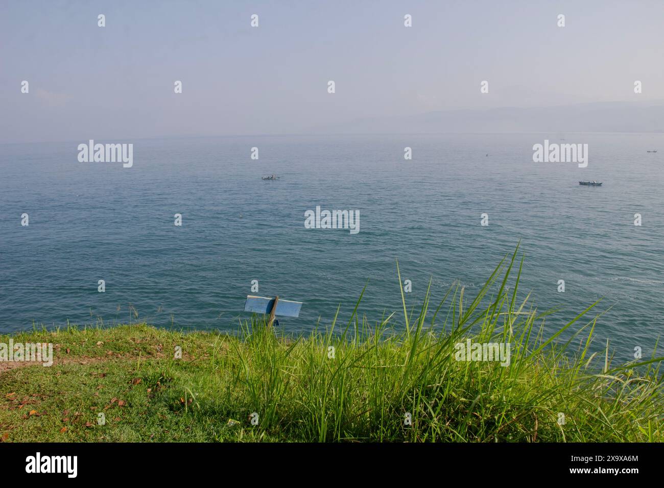 negative space in the form of a grassy hill with views of the open sea ...