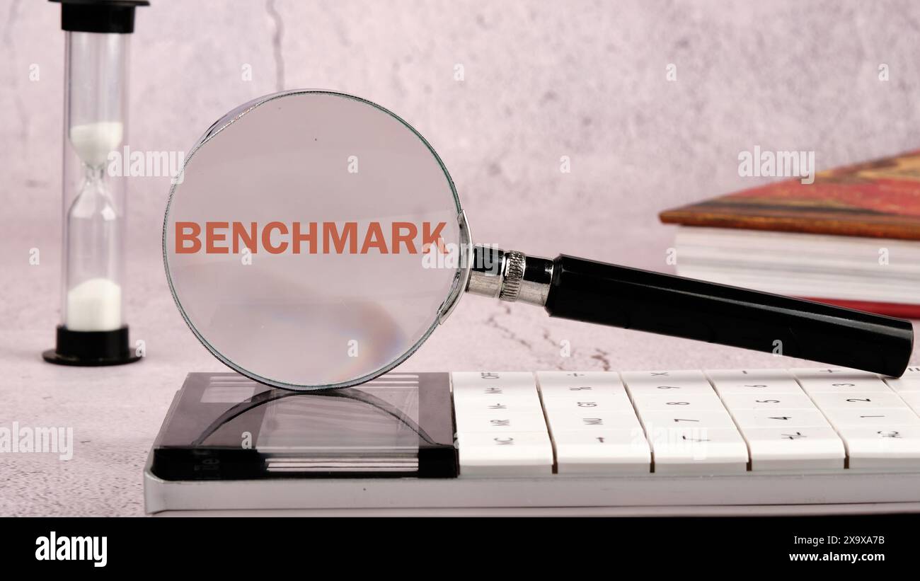 Text BENCHMARK through a magnifying glass on a calculator with an ...