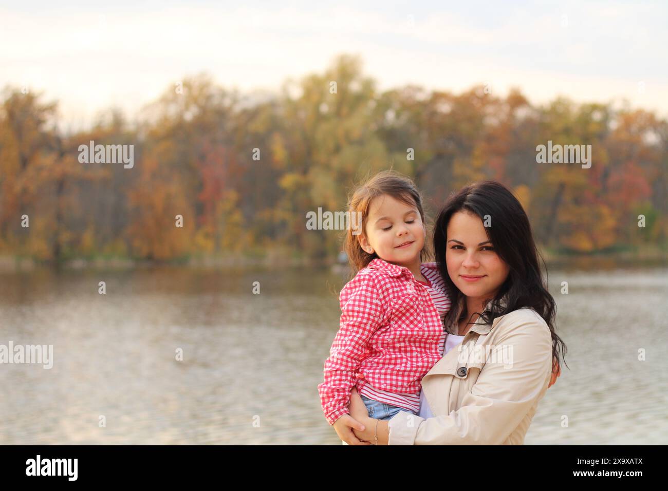 A beautiful little girl and her mother against the backdrop of an ...