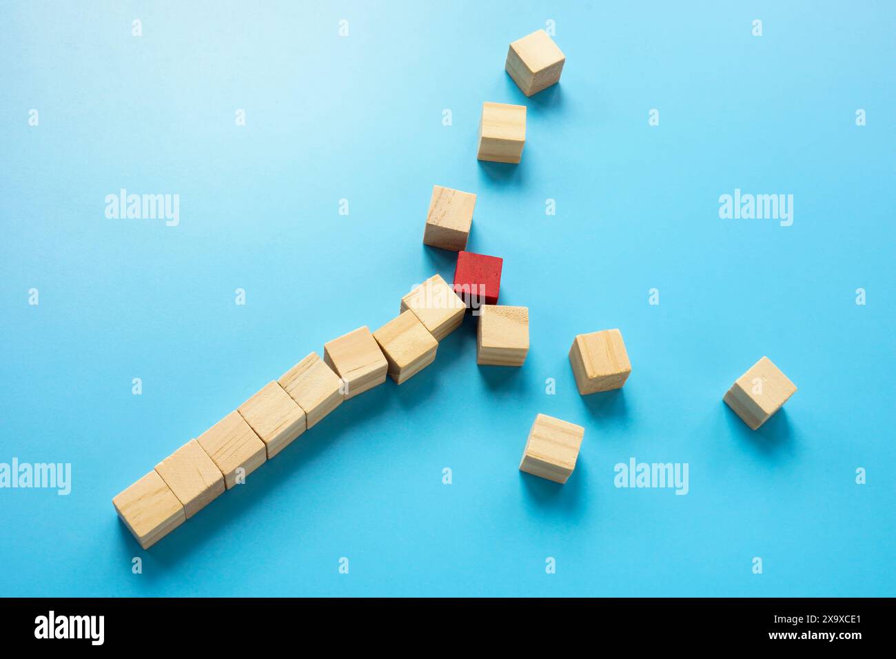 The line of cubes breaks up due to an obstacle or problem Stock Photo ...