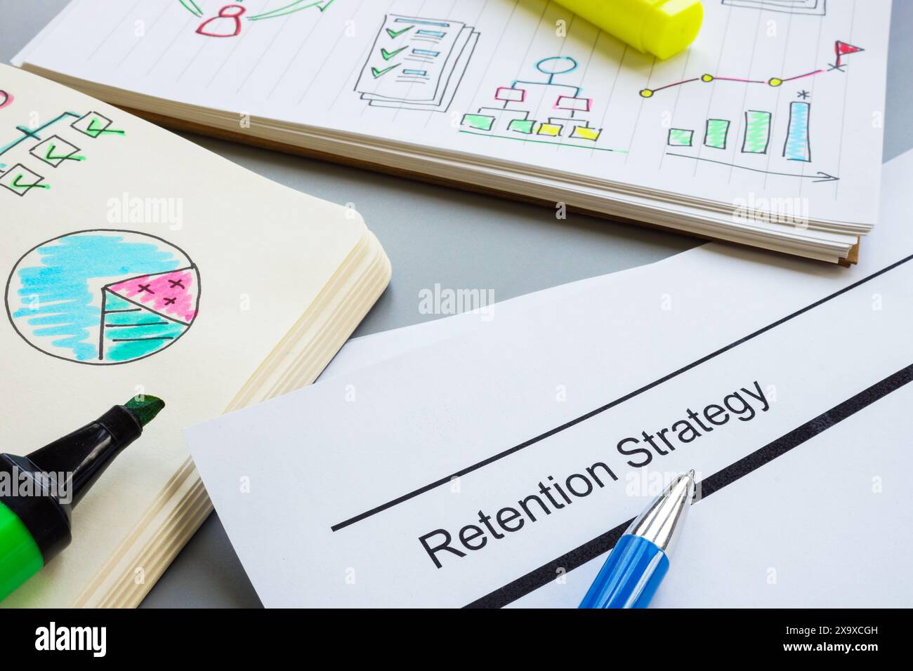 Retention strategy and notebook with charts Stock Photo - Alamy
