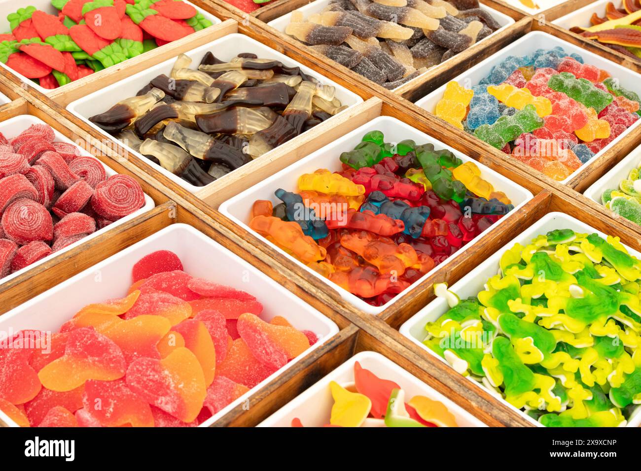 Colorful assorted gummy candies on trays for sale on marketplace. Full ...