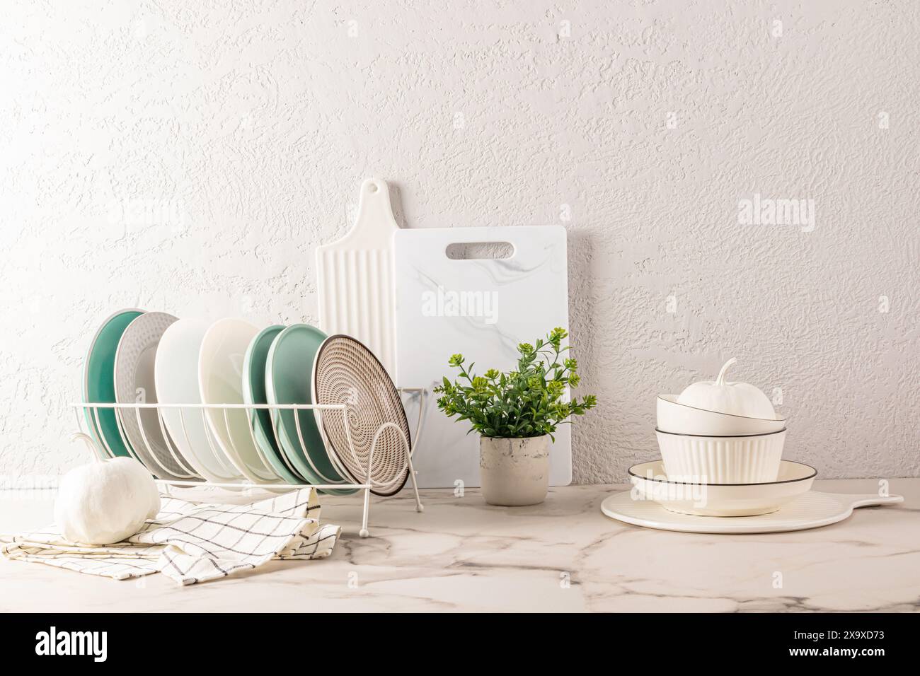 A set of ceramic utensils, white kitchen utensils on a stylish marble ...