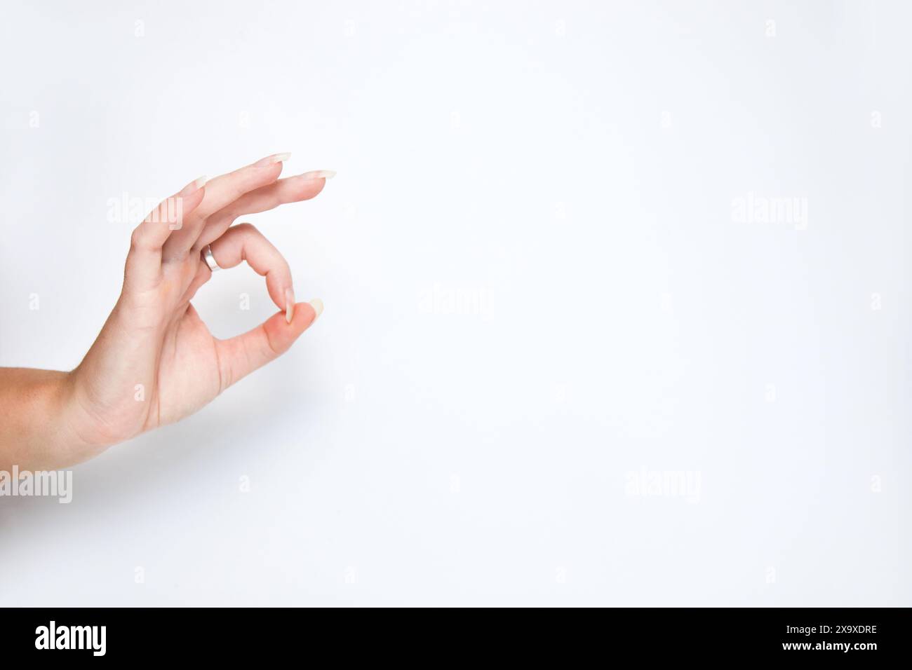 The female hand showing the ok gesture isolated on a white background ...