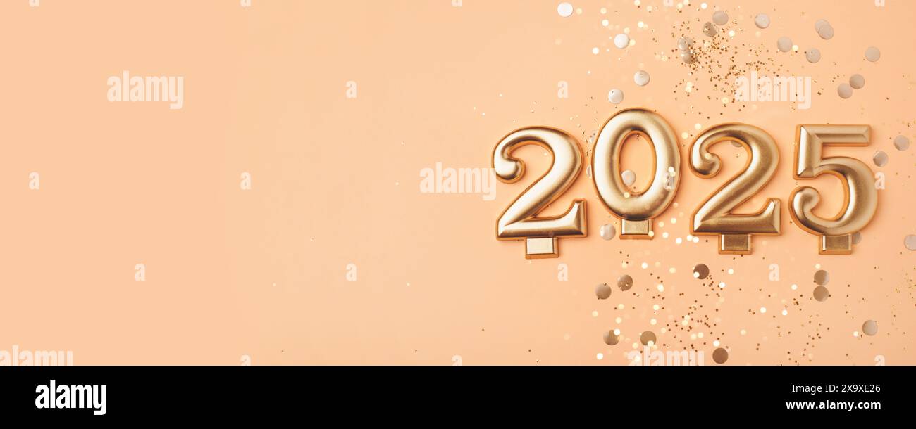Golden 2025 on a peach color background with confetti and bokeh lights. Happy New Year 2025 is ...