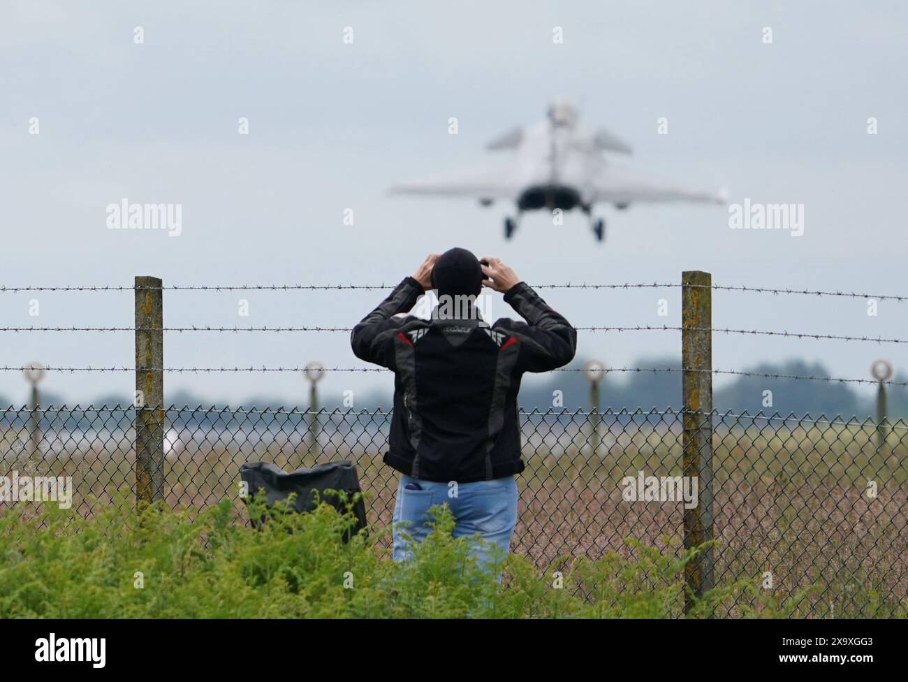 Jagel, Germany. 03rd June, 2024. A man photographs a landing fighter ...