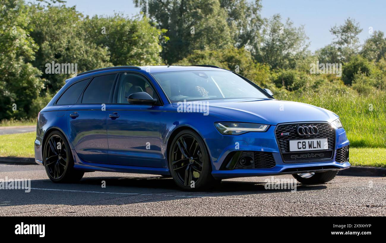 Stony Stratford,UK - June 2nd 2024: 2016 blue Audi RS6 V8 car driving on a British country road ...