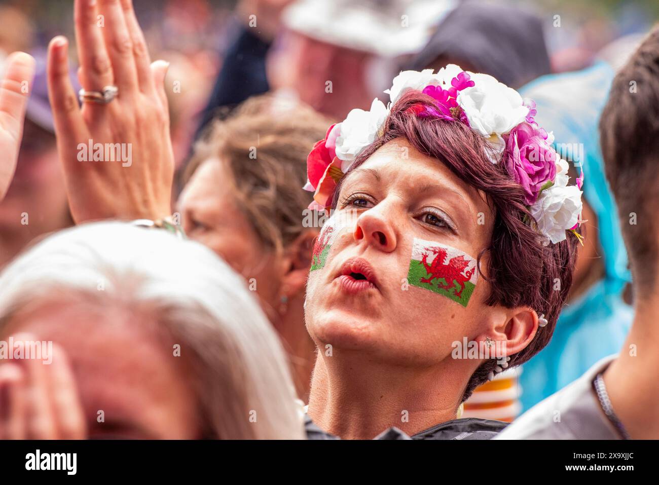 One festival goer singing along with a Welsh flag face paint and ...