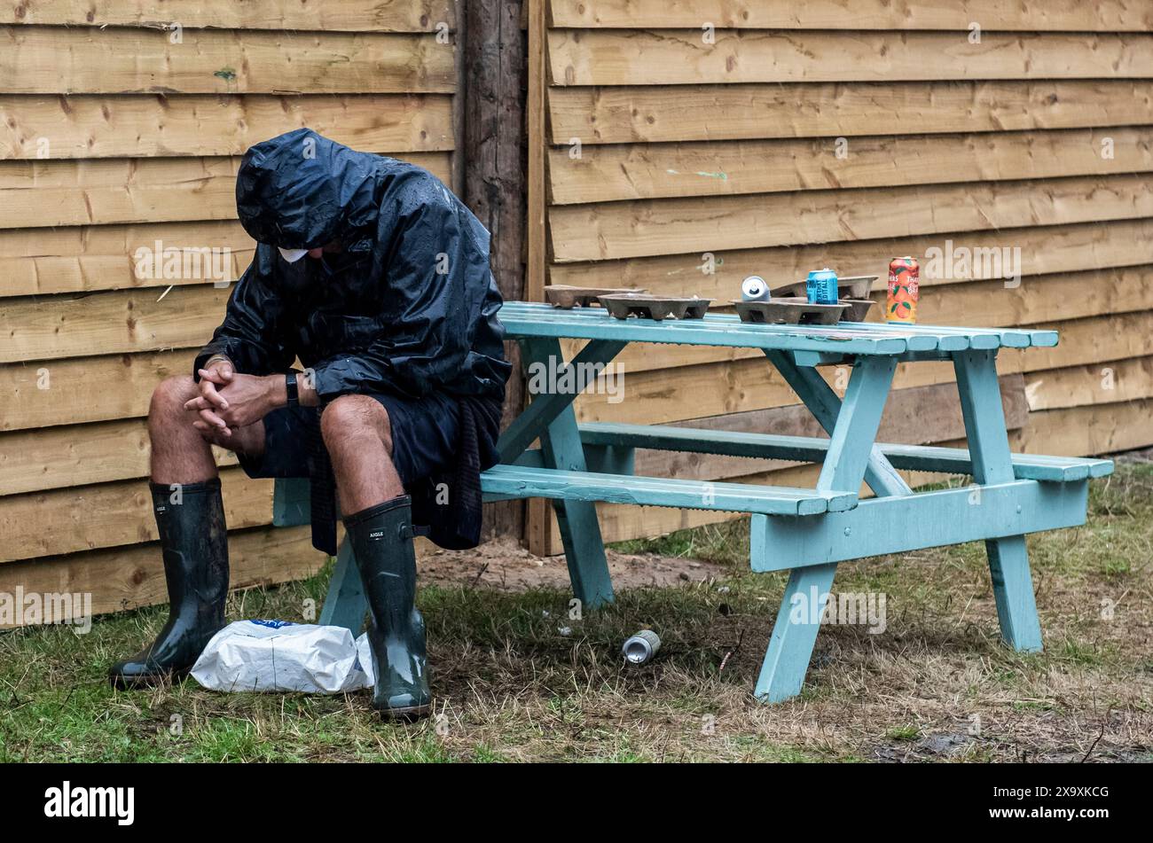 A lonely man sheltering from the rain and looking miserable at the ...