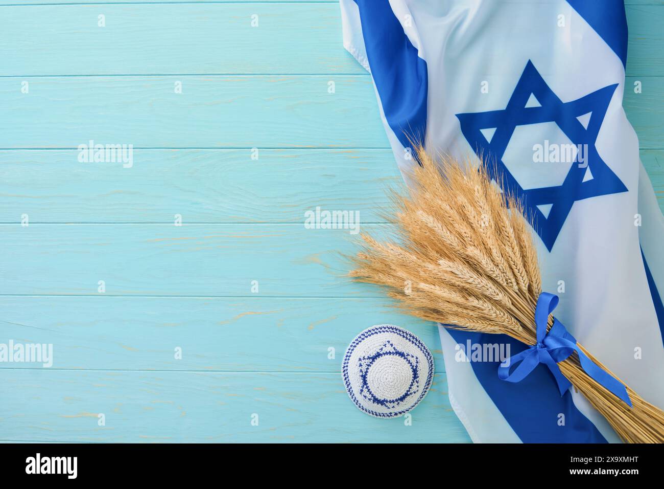 Shavuot jewish background. Ripe bouquet of wheat with blue ribbon with ...