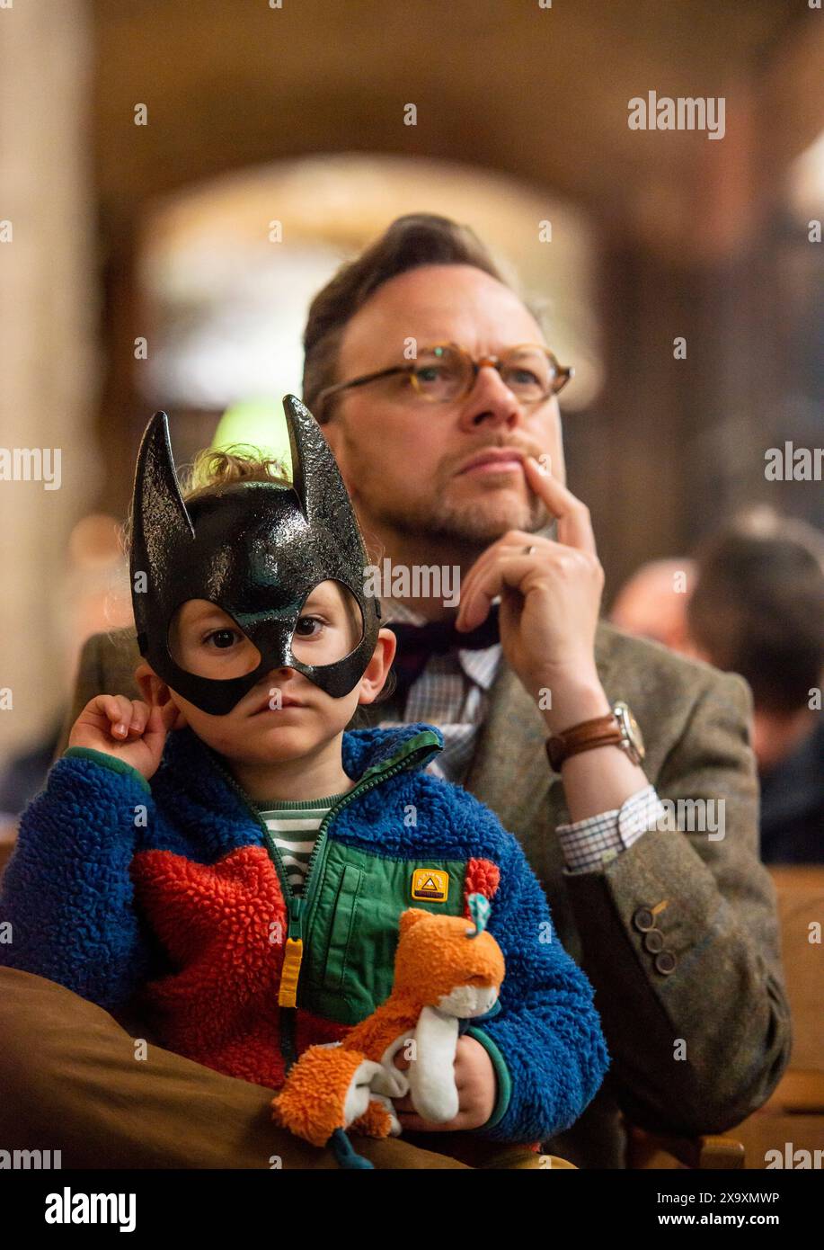 A dad watches the coronation of King Charles III in Ripon Cathedral ...