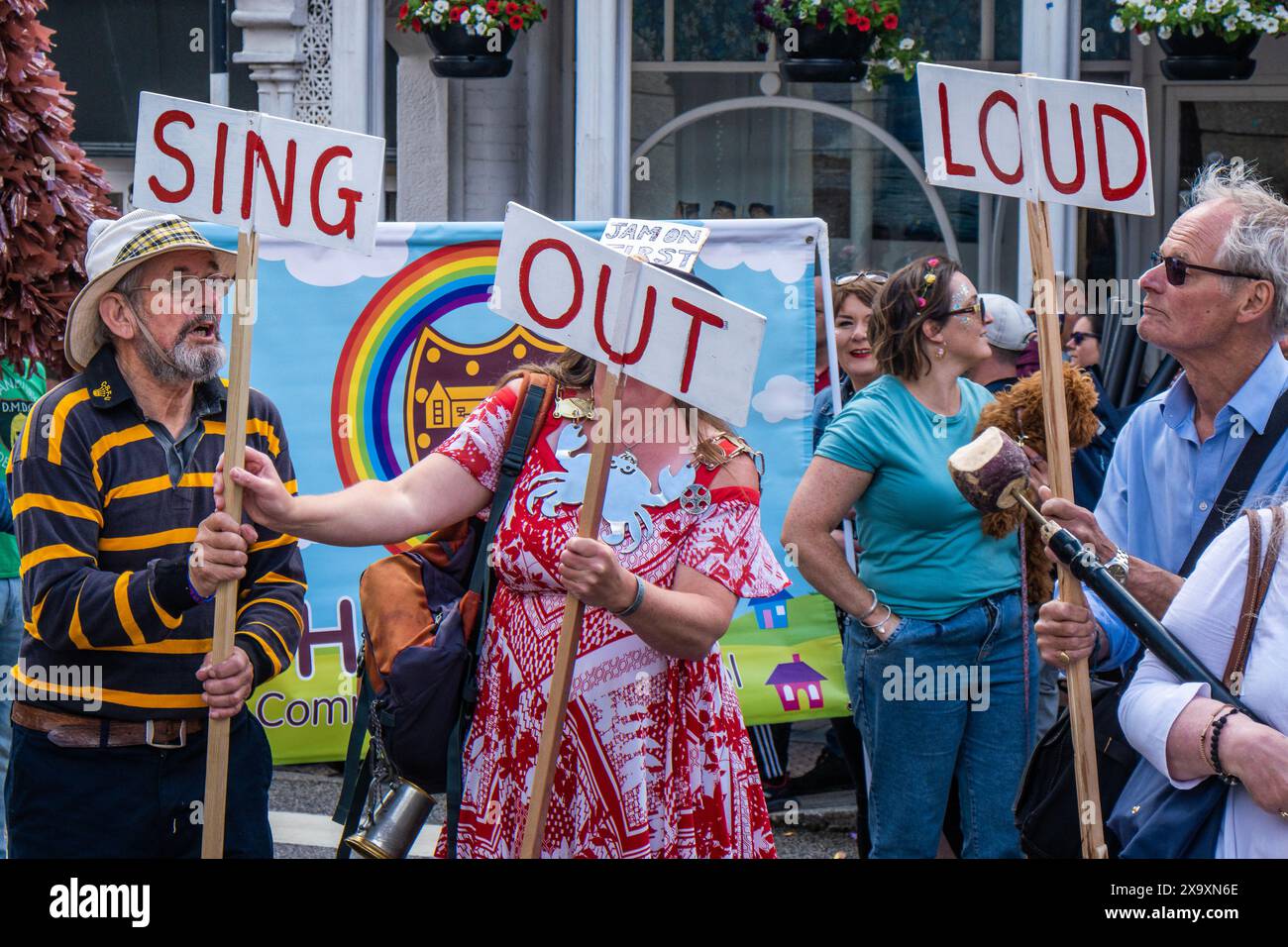People holding placards signs saying Sing Out Loud on Mazey Day during ...