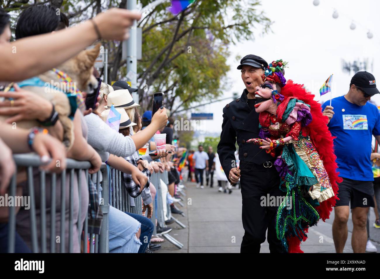 Los Angeles, USA. 02nd June, 2024. A man walks past the crowd with a ...