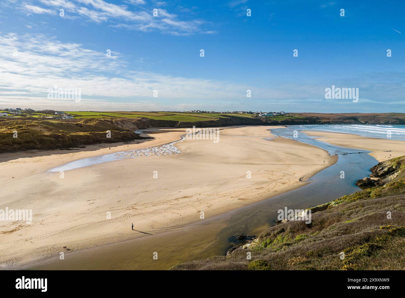 An aerial view oftThe Gannel River flowing to the sea across Crantock ...