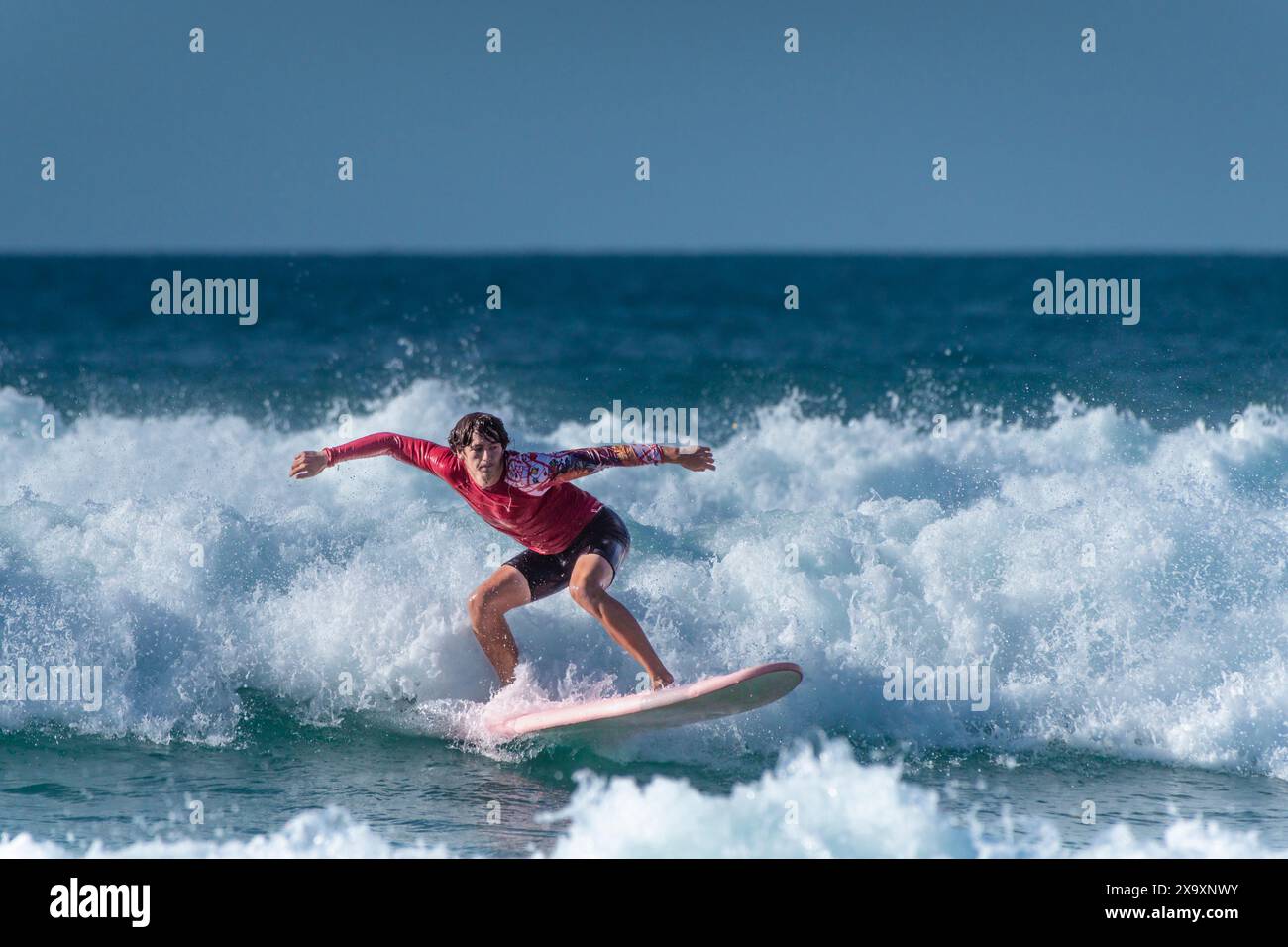 Spectacular surfing action as a male surfer rides a wave at Fistral in ...