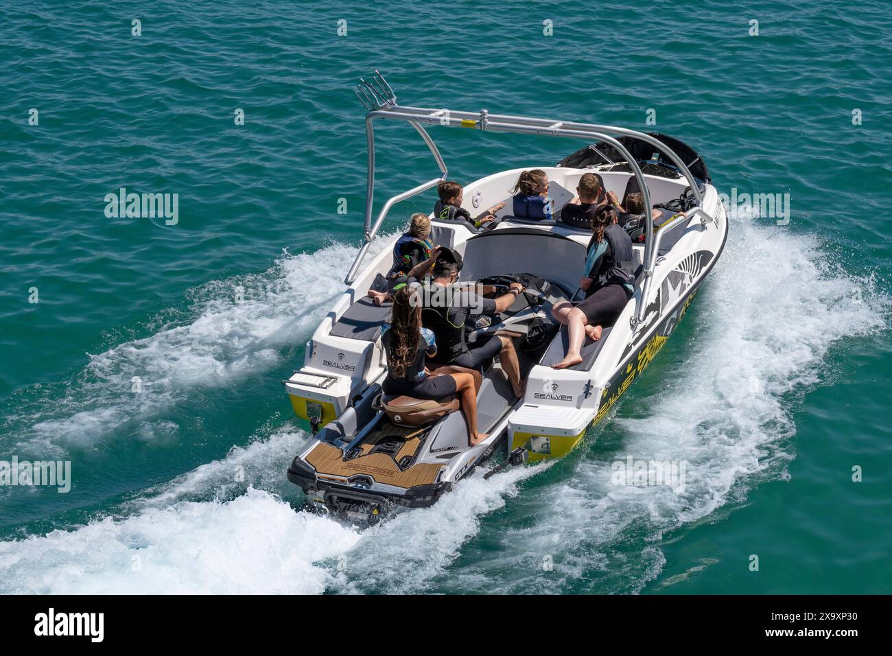 A Sealver Waveboat propelled by a jet ski with a full load of people ...
