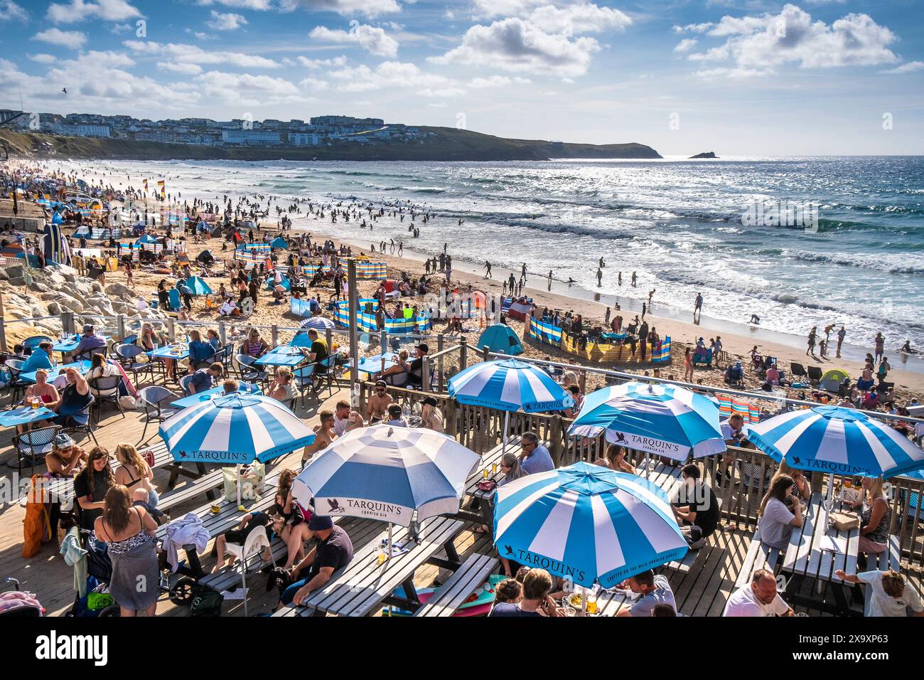 Holidaymakers on a busy crowded Fistral Beach in Newquay in Cornwall in ...