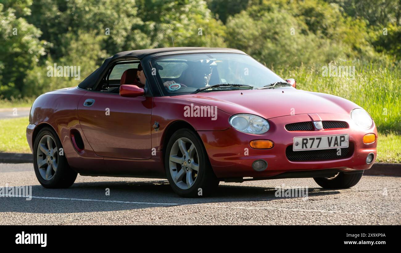 Stony Stratford,UK - June 2nd 2024: 1998 red MG MGF car driving on a ...