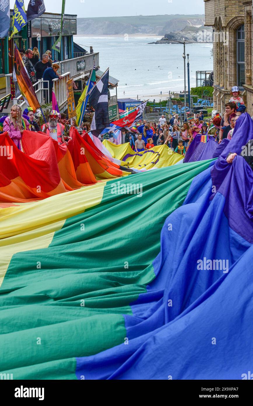 The vibrant colourful Cornwall Prides Pride flag banner held by participants in the parade in ...