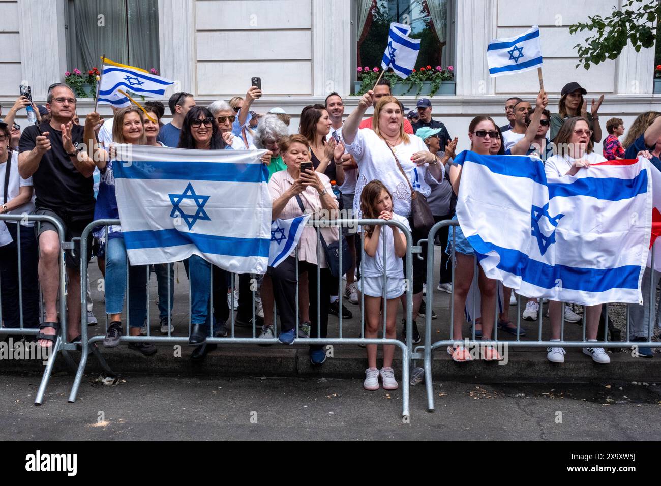 Supporters of Israel cheer on the parade with Israeli flags. The 59th ...