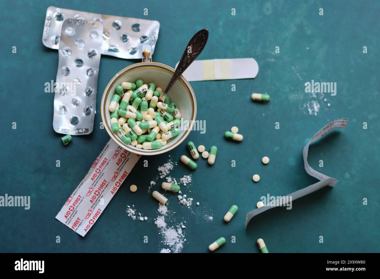 Pharmaceutical pills and capsules against textured blue background with ...
