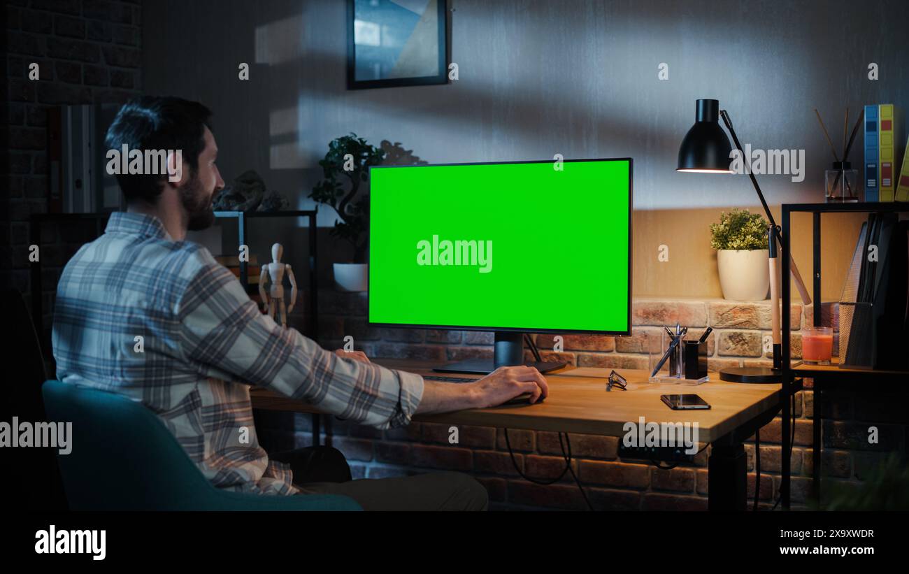 Young Attractive Man Working from Home on Desktop Computer with Green ...